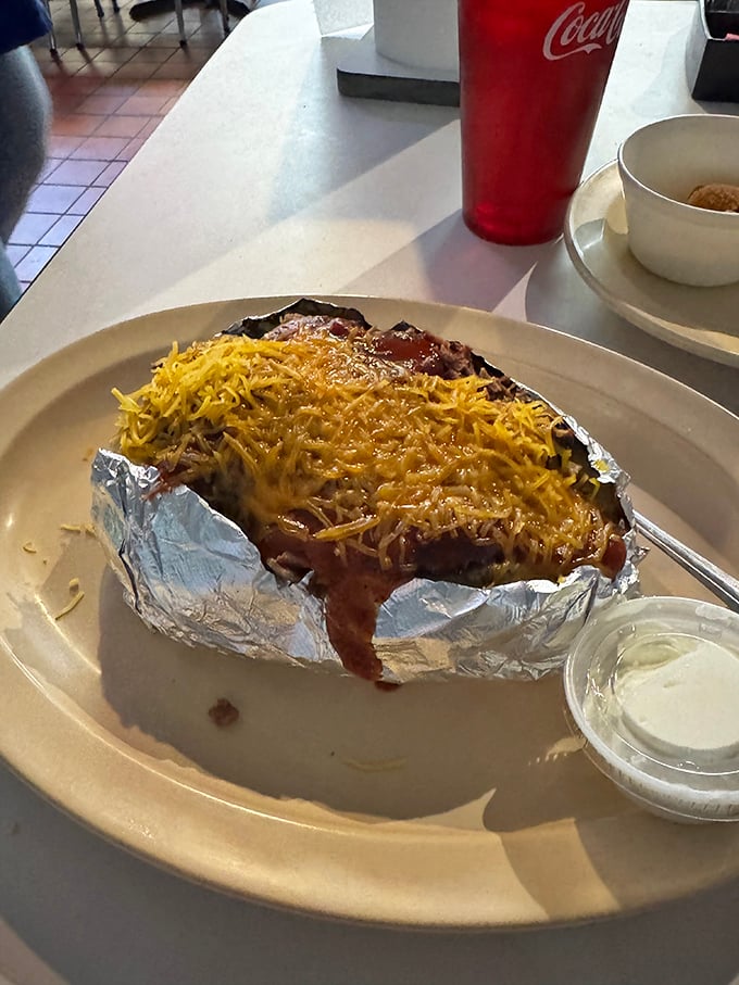 A loaded baked potato wrapped in foil like the culinary gift it truly is. Cheese melting into every nook and cranny is nature's perfect design.
