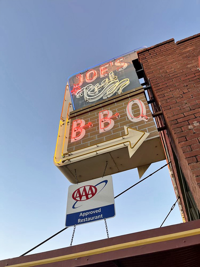 That neon sign doesn't just advertise – it beckons like a barbecue lighthouse guiding hungry souls to smoky salvation.