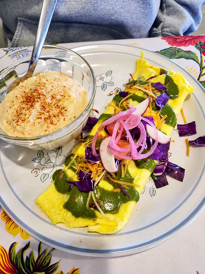 This isn't just an omelet—it's a garden-fresh masterpiece topped with vibrant vegetables and a side of grits that would make any Southerner proud.