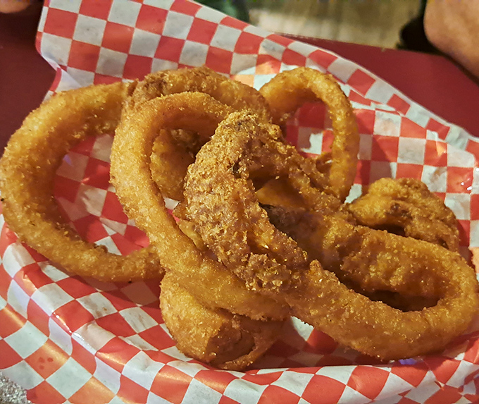 Onion rings with that perfect golden crunch. Served in a checkered basket – the universal signal for "good times ahead."