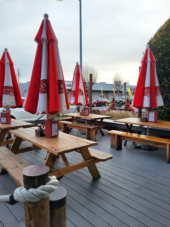 The outdoor deck with its picnic tables and red umbrellas—where lobster rolls taste even better under California sunshine.