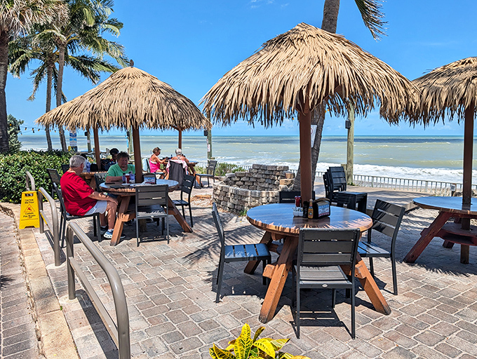These flame-red Adirondack chairs aren't just seating; they're front-row tickets to the greatest show on earth – the Atlantic Ocean at play.