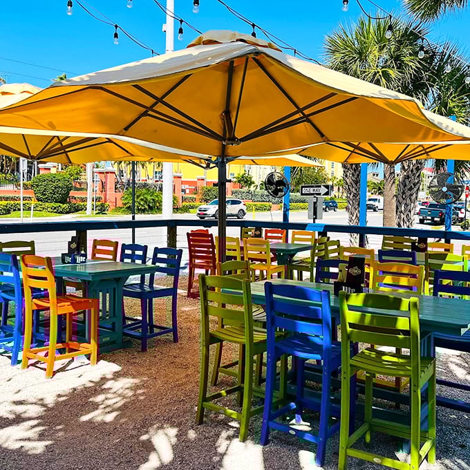 Outdoor seating in a rainbow of chairs that's more cheerful than a beach umbrella convention. Florida dining as it should be—colorful and sun-kissed.