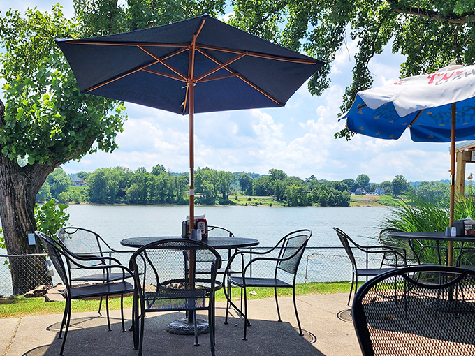 Riverside dining elevates every bite while umbrellas provide shade for contemplating life's simple pleasures and exceptional pulled pork.