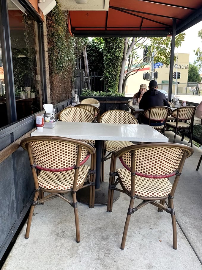 The outdoor seating area offers fresh air with your fresh eggs—a California breakfast luxury where nature and nurture meet.
