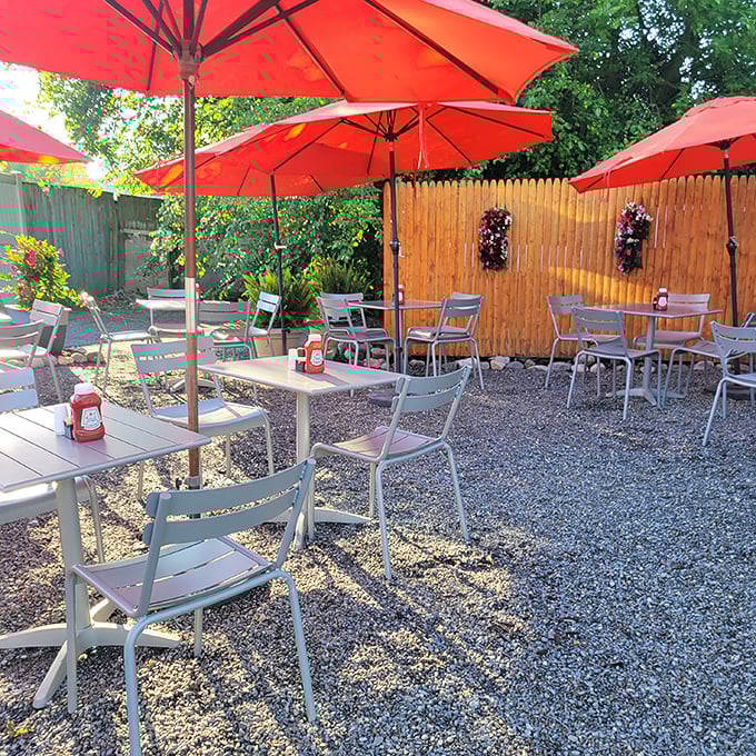 The outdoor seating area—where bright umbrellas create islands of shade and breakfast tastes even better with a side of fresh air.