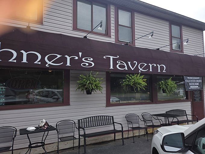 The outdoor seating area, with its hanging plants and sturdy benches, practically whispers "come sit awhile" to passersby on pleasant Ohio evenings.