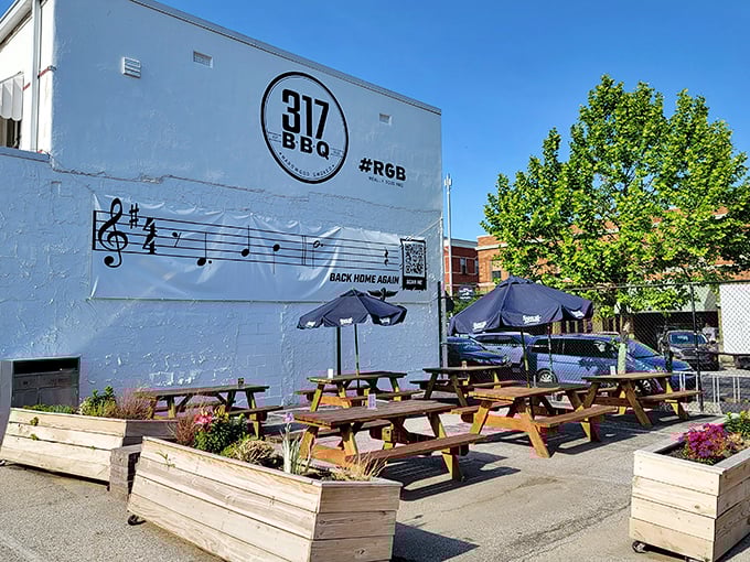 The outdoor patio – where picnic tables, umbrellas, and the wafting scent of smoke create the perfect urban oasis for meat enthusiasts.