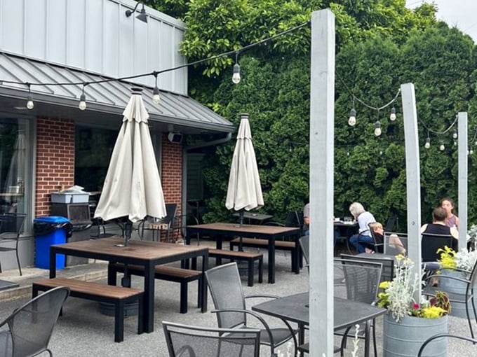 Outdoor seating that begs for lazy summer mornings. Those string lights aren't just decoration—they're permission to linger until dusk.