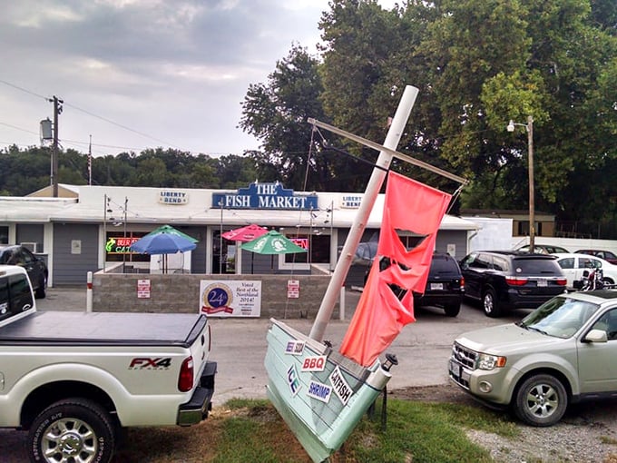 The parking lot view reveals the restaurant's modest footprint – proof that culinary greatness doesn't require fancy real estate, just passion and good recipes.