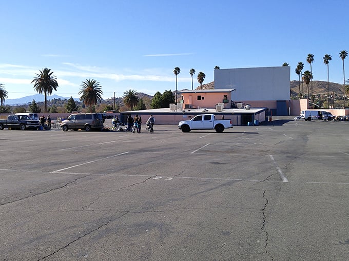 The vast parking area fills with expectant moviegoers as the workday ends and entertainment begins.