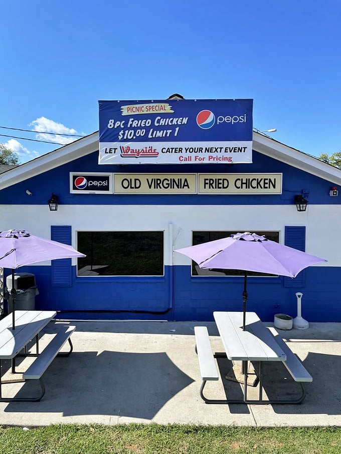 The outdoor seating area: where picnic tables and umbrellas invite you to enjoy your "Old Virginia Fried Chicken" under the blue Charlottesville sky.