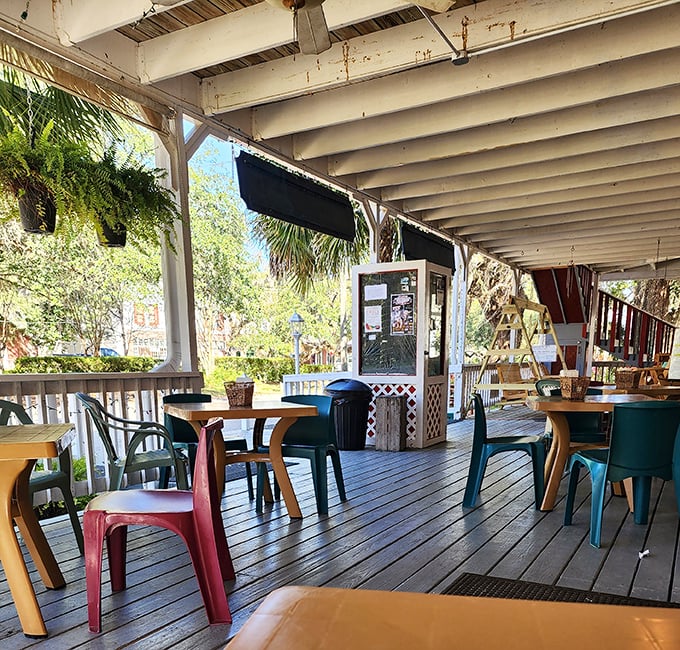 The porch dining area offers the kind of authentic Florida experience that no theme park could ever replicate—just good food, fresh air, and zero animatronics.