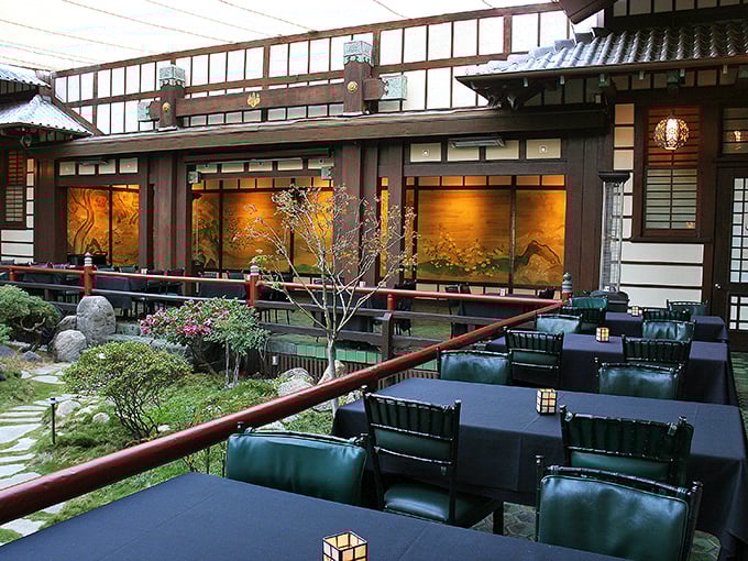 The courtyard dining area overlooks a traditional Japanese garden where tranquility comes complimentary with every meal.