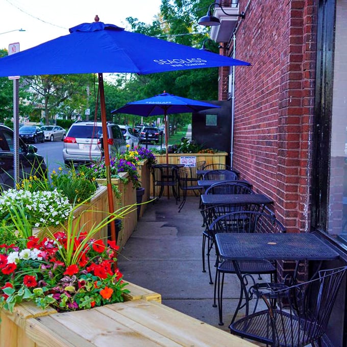 The outdoor patio, where summer evenings transform into something magical. Those flower boxes aren't just decorative—they're setting the stage for memorable meals.