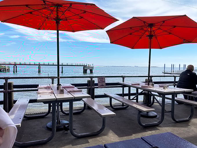 The outdoor patio where fresh air comes complimentary with every order, and orange umbrellas stand guard against the Carolina sunshine.