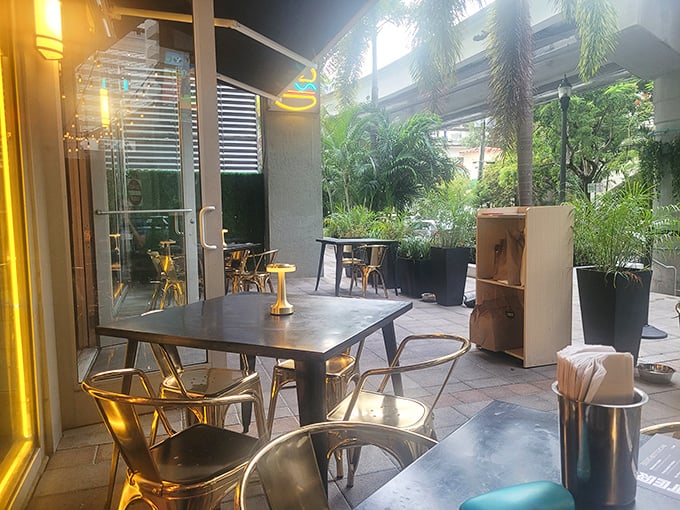 The outdoor patio offers Miami's version of al fresco dining: tropical plants, modern furniture, and the promise of burgers to come.