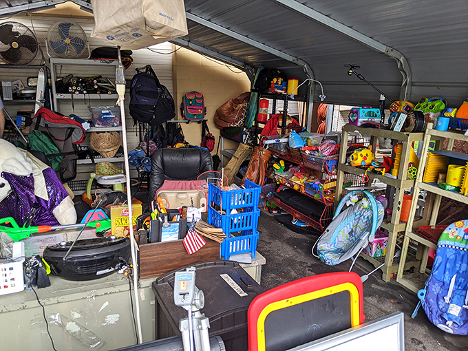 Organized chaos at its finest! This storage unit reveals the beautiful randomness of thrift store inventory—where a leather office chair neighbors a child's beach toy in perfect harmony.