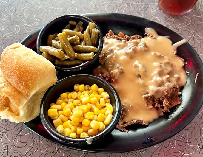 Gravy isn't just a condiment here—it's a commitment. This open-faced roast beef sandwich doesn't know the meaning of restraint.