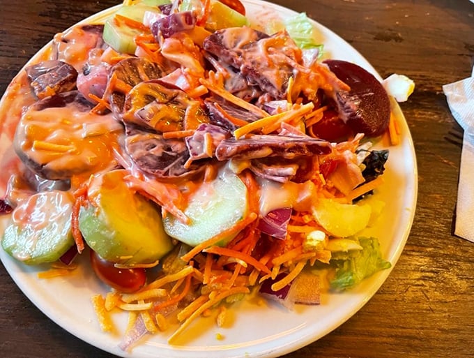A salad that makes you feel virtuous for approximately three seconds before heading back for more ribs. Balance achieved.
