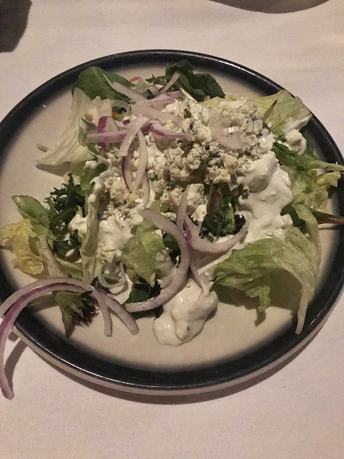 A house salad that defies steakhouse stereotypes – crisp, thoughtful, and adorned with just the right amount of blue cheese.