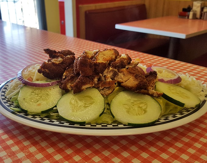 Crispy chicken atop fresh cucumber slices—proof that sometimes diners do vegetables without deep-frying them first.