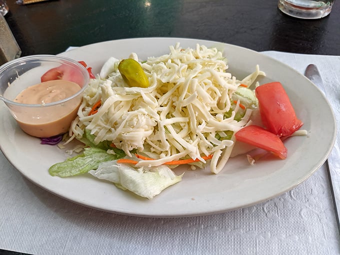 A simple house salad with shredded cheese and thousand island dressing – the perfect opening act before the pizza headliner.
