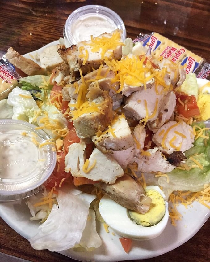 The salad arrives looking substantial enough to feed a small village, because even vegetables get supersized here.
