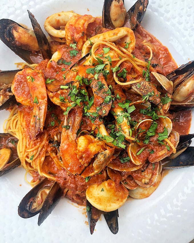 Seafood pasta that would make an Italian grandmother nod in approval. The ocean and garden having a delicious reunion on your plate.