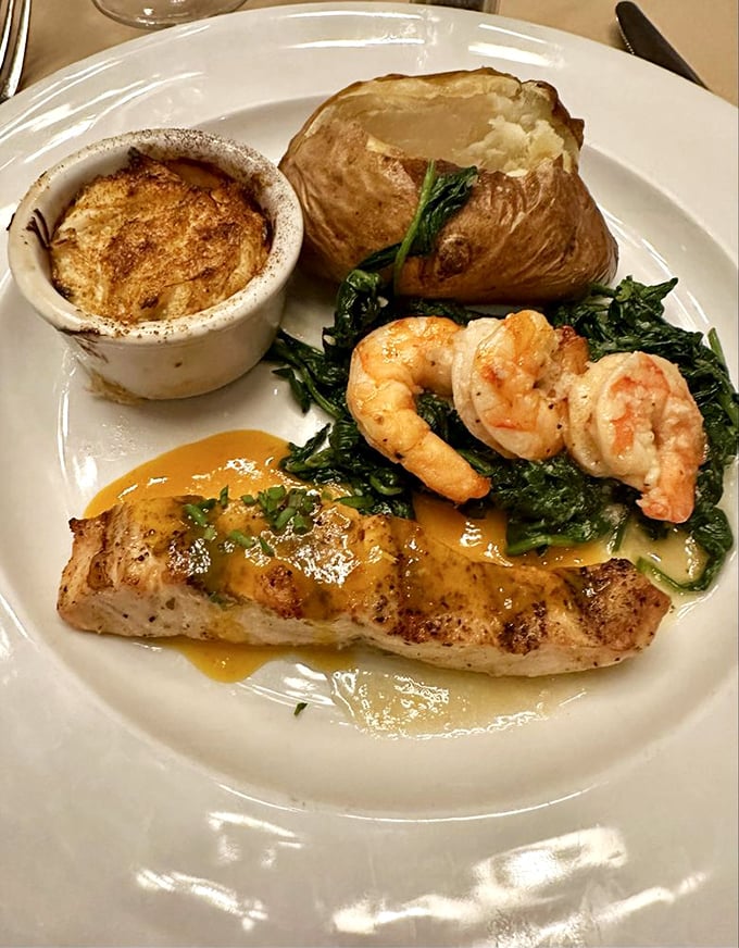 A symphony of seafood: perfectly seared fish, plump shrimp, and creamy potatoes, all harmonizing on a plate that showcases the kitchen's finesse.