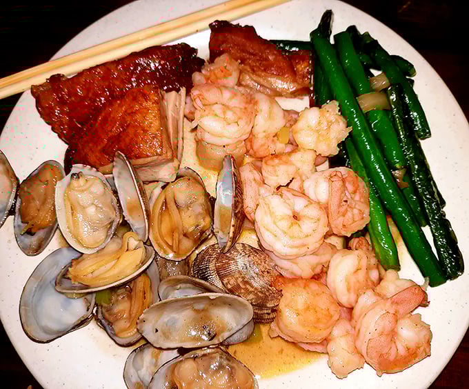 This seafood medley featuring plump shrimp, tender clams, and succulent pork is the oceanic equivalent of hitting the culinary jackpot.