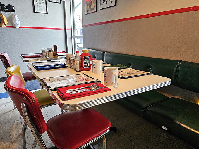 Green booth seating and colorful chairs create the perfect backdrop for breakfast diplomacy—where pancake treaties are negotiated over coffee.