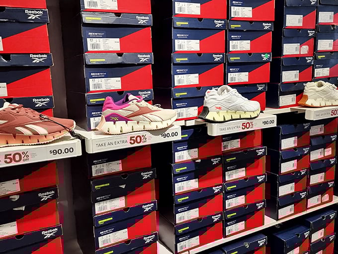 The shoe wall of dreams—where 50% off signs create the kind of excitement usually reserved for winning lottery numbers.