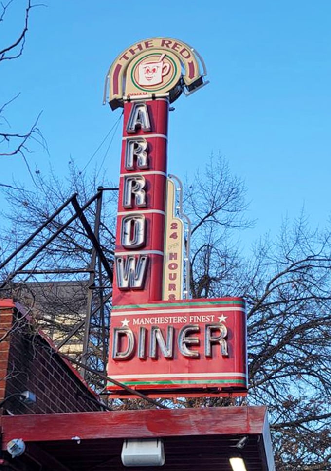 The neon sign glows against the Manchester sky, a beacon of hope for the hungry that has guided generations to breakfast bliss.