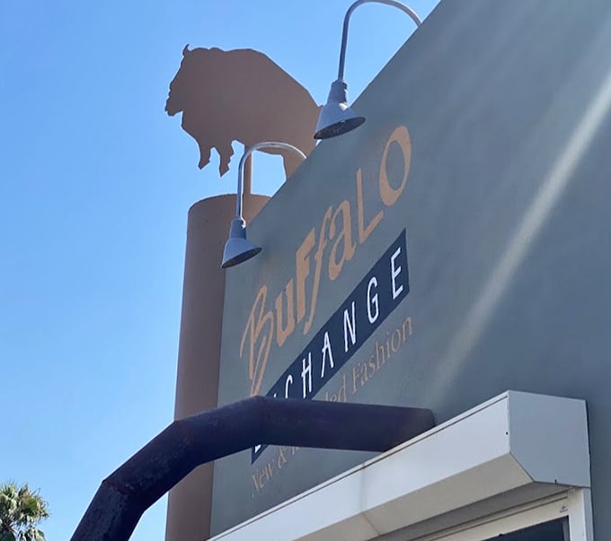 The iconic buffalo silhouette stands sentinel against the Tucson sky, a beacon for bargain hunters and sustainable fashion seekers alike.
