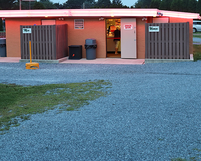 The snack bar's pink glow signals intermission treats – the essential companion to any proper drive-in experience.