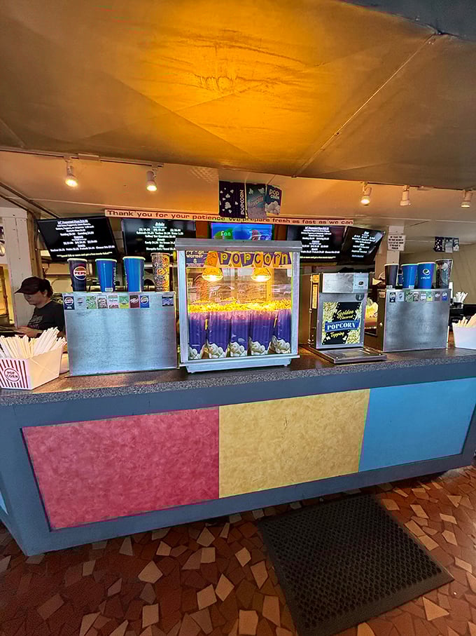 Popcorn machines glow like treasure chests, promising that perfect combination of salt, butter and nostalgia with every kernel.