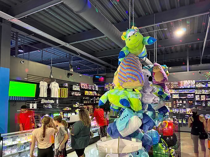 The prize redemption area dangles plush temptations from above, like a colorful reminder that you're never too old to want a stuffed alien.