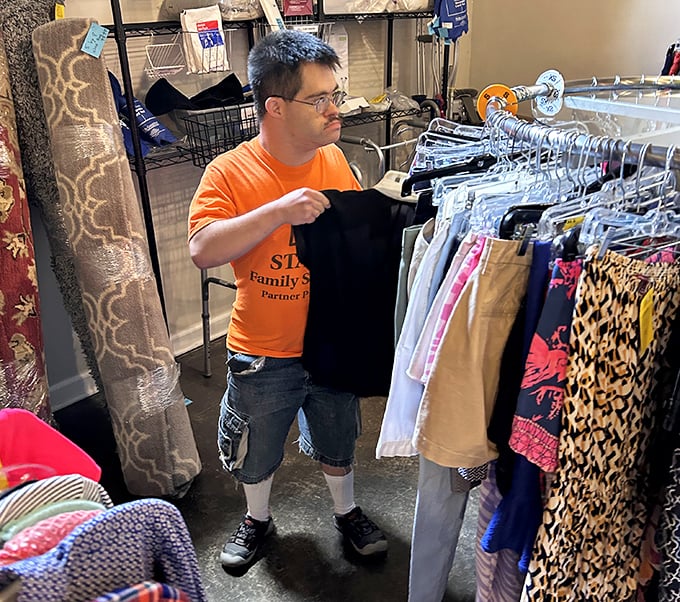 Staff members don the signature orange shirts with pride—thrift store superheroes whose powers include organization, curation, and community service.