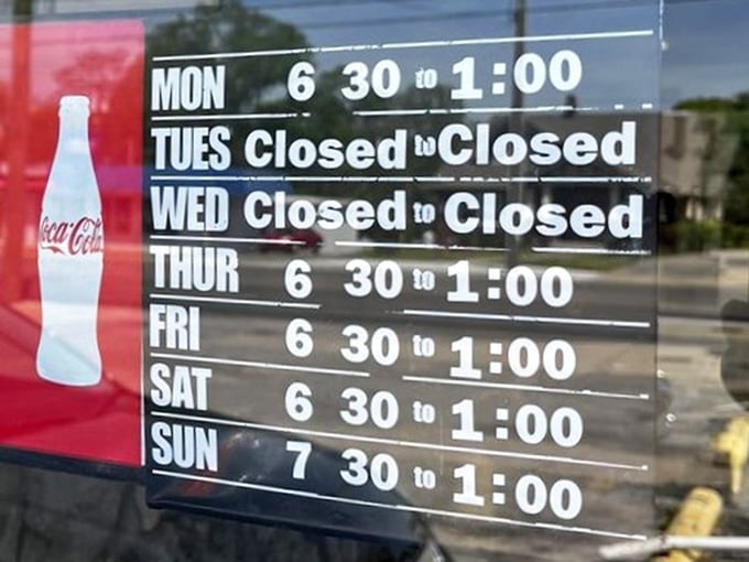 The hours sign reads like poetry to early risers—a schedule that respects the sanctity of breakfast and the importance of Tuesdays off.