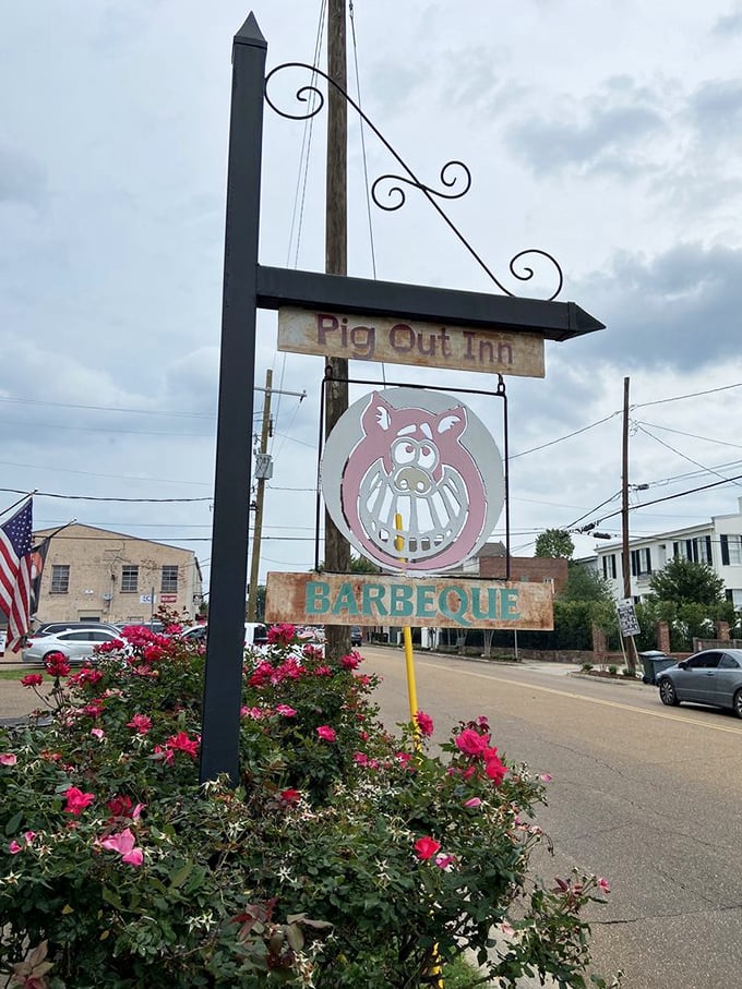 The roadside sign doesn't need fancy graphics or flashing lights—when your barbecue speaks this loudly, a simple pig logo is all you need.