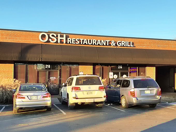 As the sun sets, OSH's storefront glows with promise. Cars in the parking lot tell the story—locals know where the good stuff is.