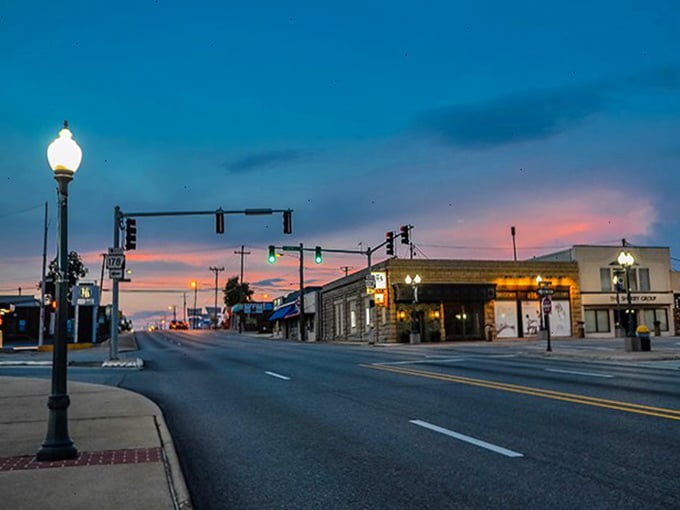 Twilight transforms Main Street into a painting. Those traffic lights aren't just signals—they're community timepieces.