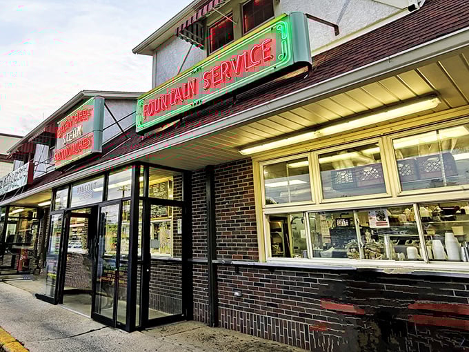 The neon "Fountain Service" sign glows like a promise that milkshakes here will make you question why you ever settled for less.