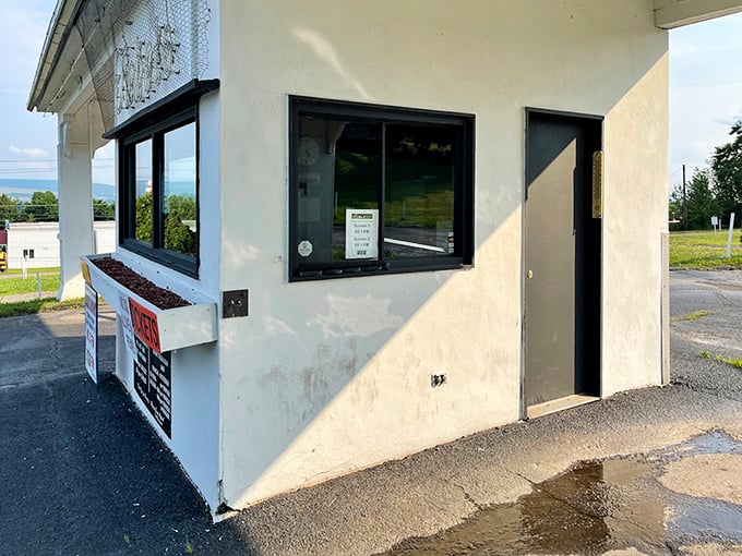 The humble ticket booth—gateway to memories that will outlast the evening, where anticipation begins and reality takes a two-hour intermission.