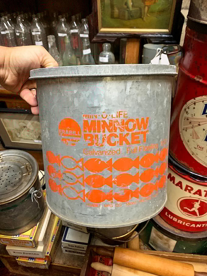 Minnow Bucket,’ reads the faded orange print on this galvanized relic—a reminder of lazy summer days, tin pails, and quiet fishing trips long before screens stole the spotlight.