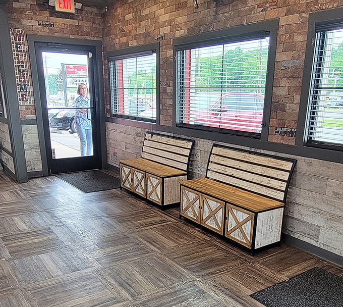 The waiting area's rustic benches suggest patience will be rewarded—good things come to those who wait for properly smoked meat.
