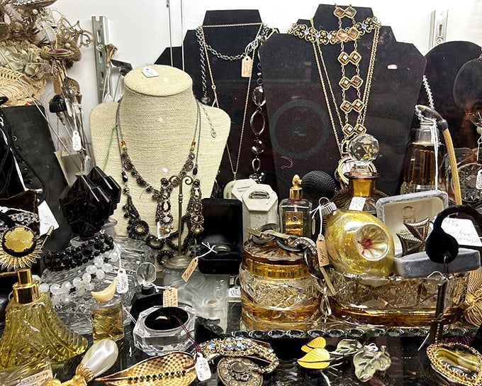A treasure chest of vintage glamour—where perfume bottles and costume jewelry create a still life worthy of a Jazz Age socialite's dressing table.