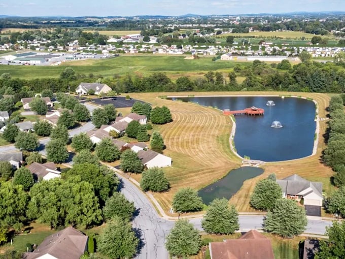 The bird's-eye view reveals the master plan – homes nestled around water, not squeezed between parking lots. Retirement reimagined from above.