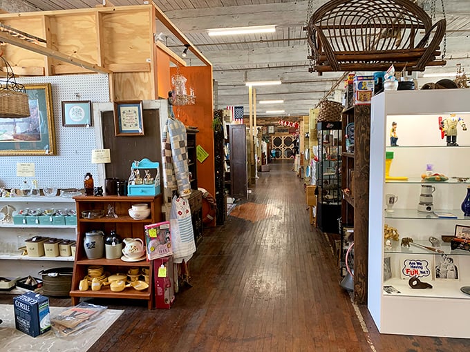 Wooden floors that creak with stories lead you through aisles of organized chaos—each vendor space its own chapter in the antique adventure.